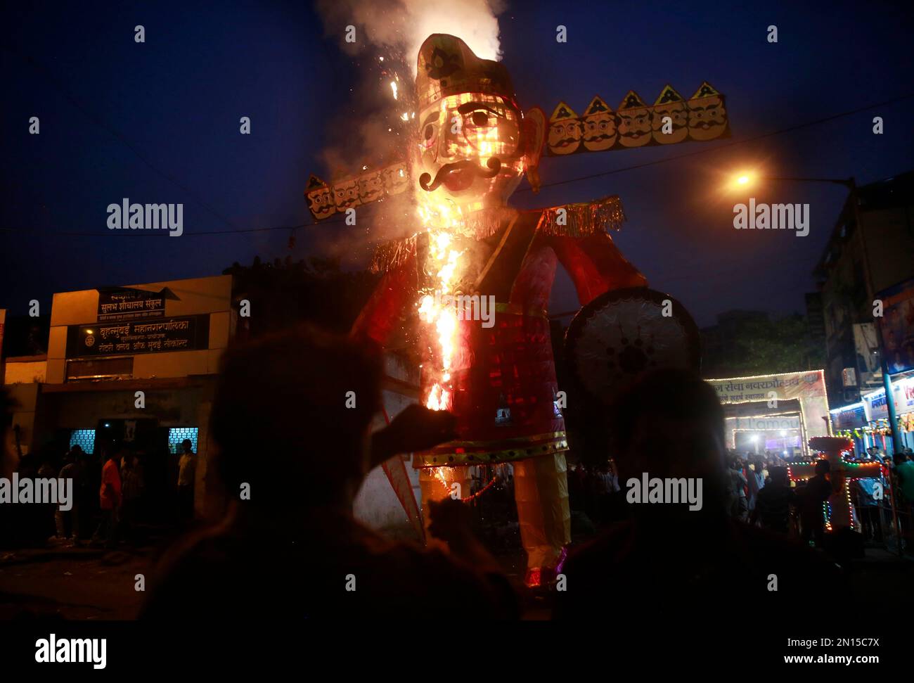 People watch an effigy of the ten-headed demon king Ravana go up in ...
