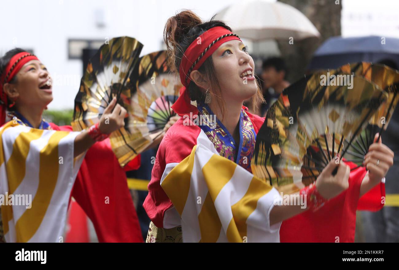 Participants with fans perform "yosakoi" folk dance as they parade ...