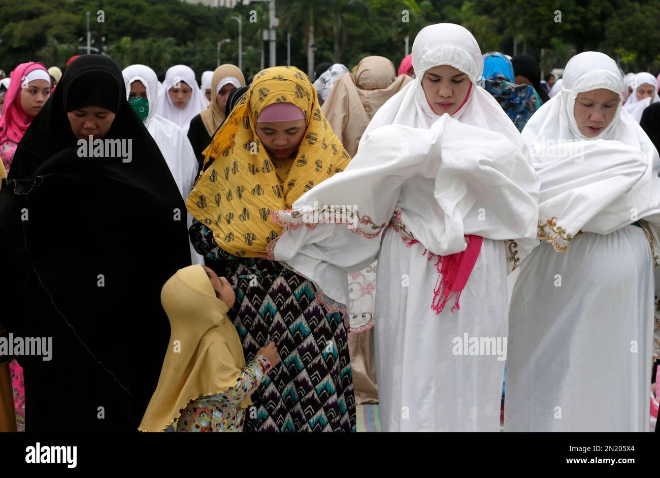 Filipino Muslims pray as they gather at Manila's Rizal Park to mark the end of the Holy month of ...