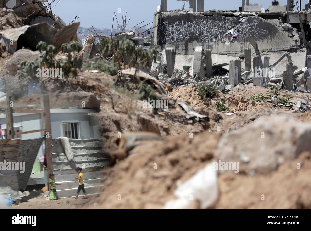 In this June 17, 2015 photo, Palestinian girls are seen reflected in a ...