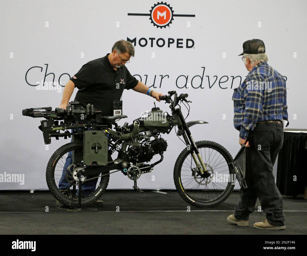 Ken Stone, left, with Motoped, demonstrates the Motoped Survival Bike ...