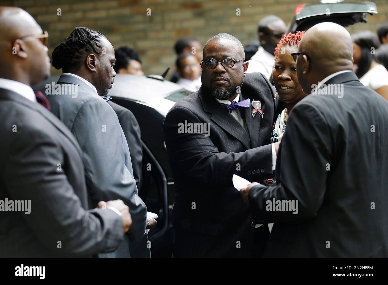 Anthony Scott, center, the brother of Walter Scott, embraces a mourner ...