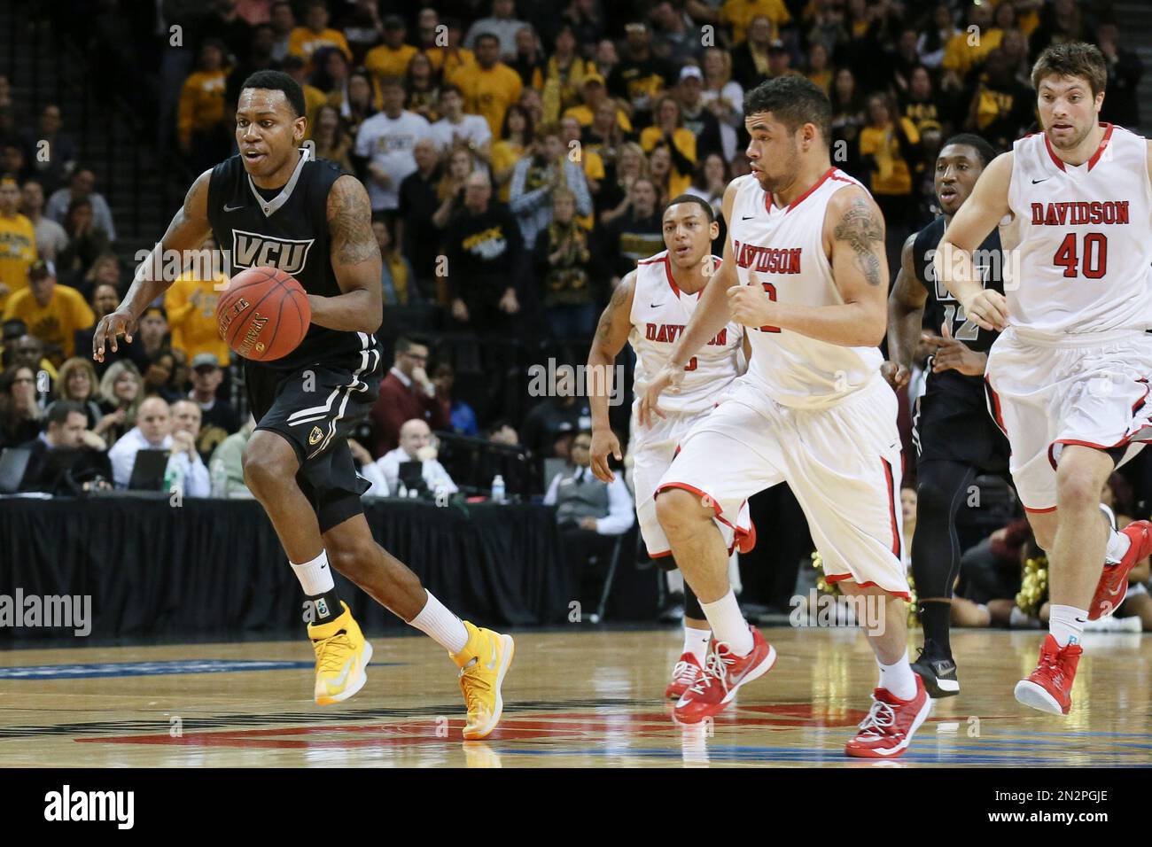 VCU guard/forward Treveon Graham (21) dribbles up court as Davidson ...