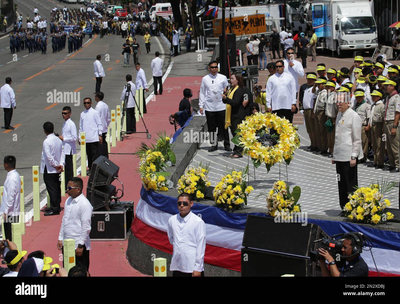 Philippine President Benigno Aquino III, right, stands to witness the ...