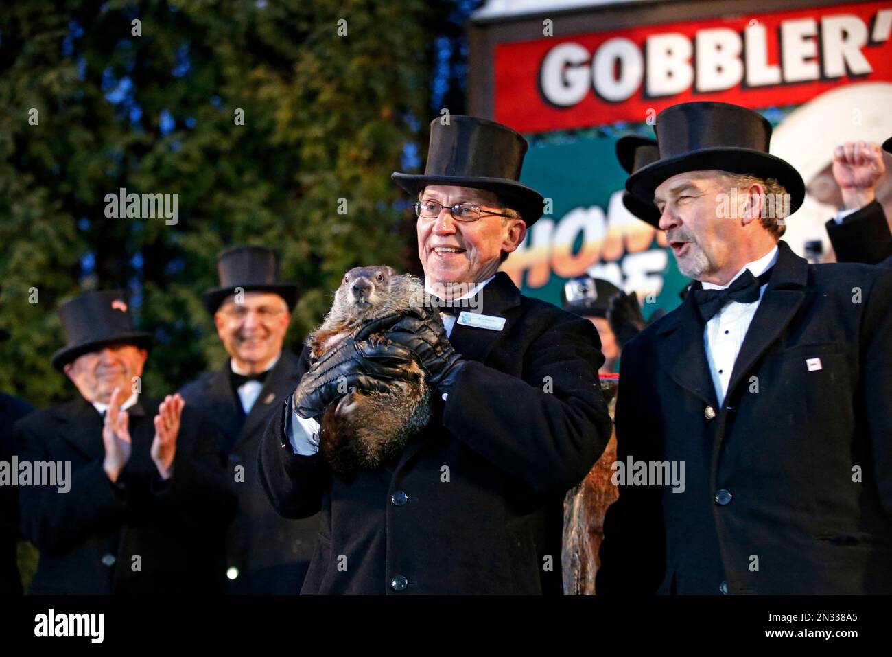 Groundhog Club handler Ron Ploucha, center, holds Punxsutawney Phil ...
