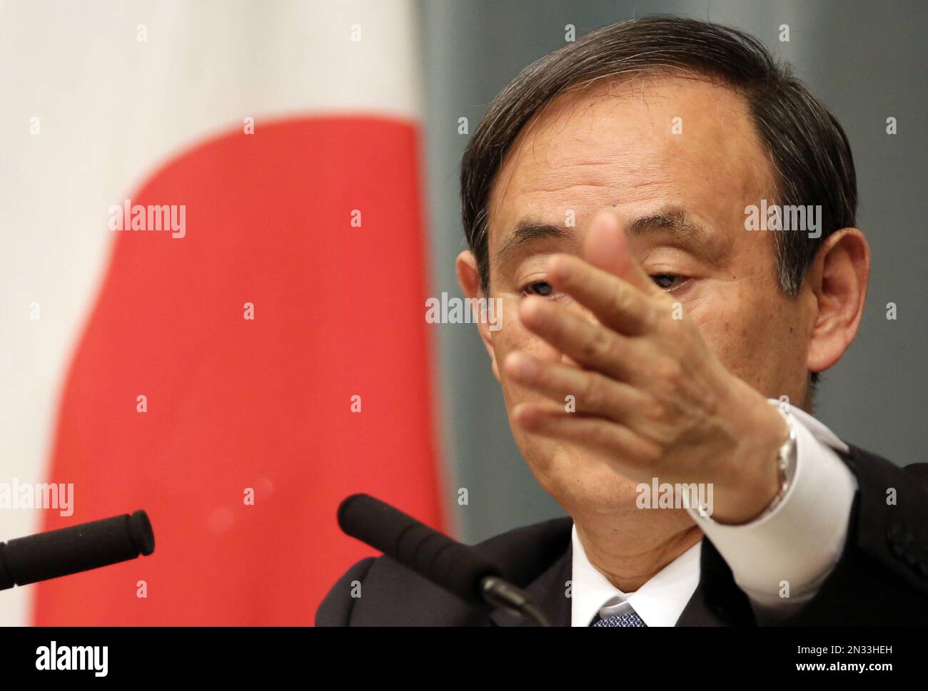 Japan's Chief Cabinet Secretary Yoshihide Suga receives a question from ...