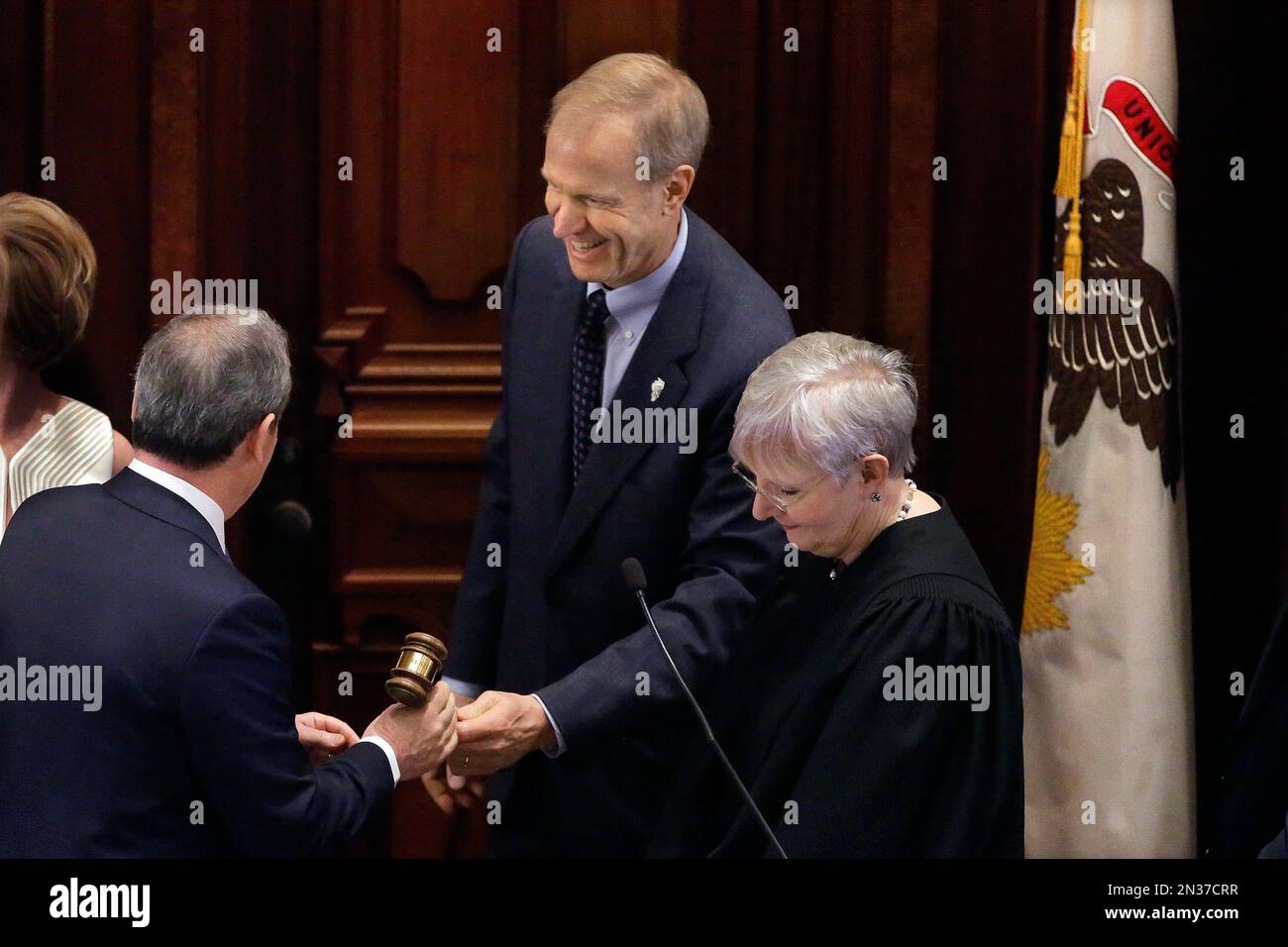Illinois Gov. Bruce Rauner, center, hands the gavel to newly elected ...