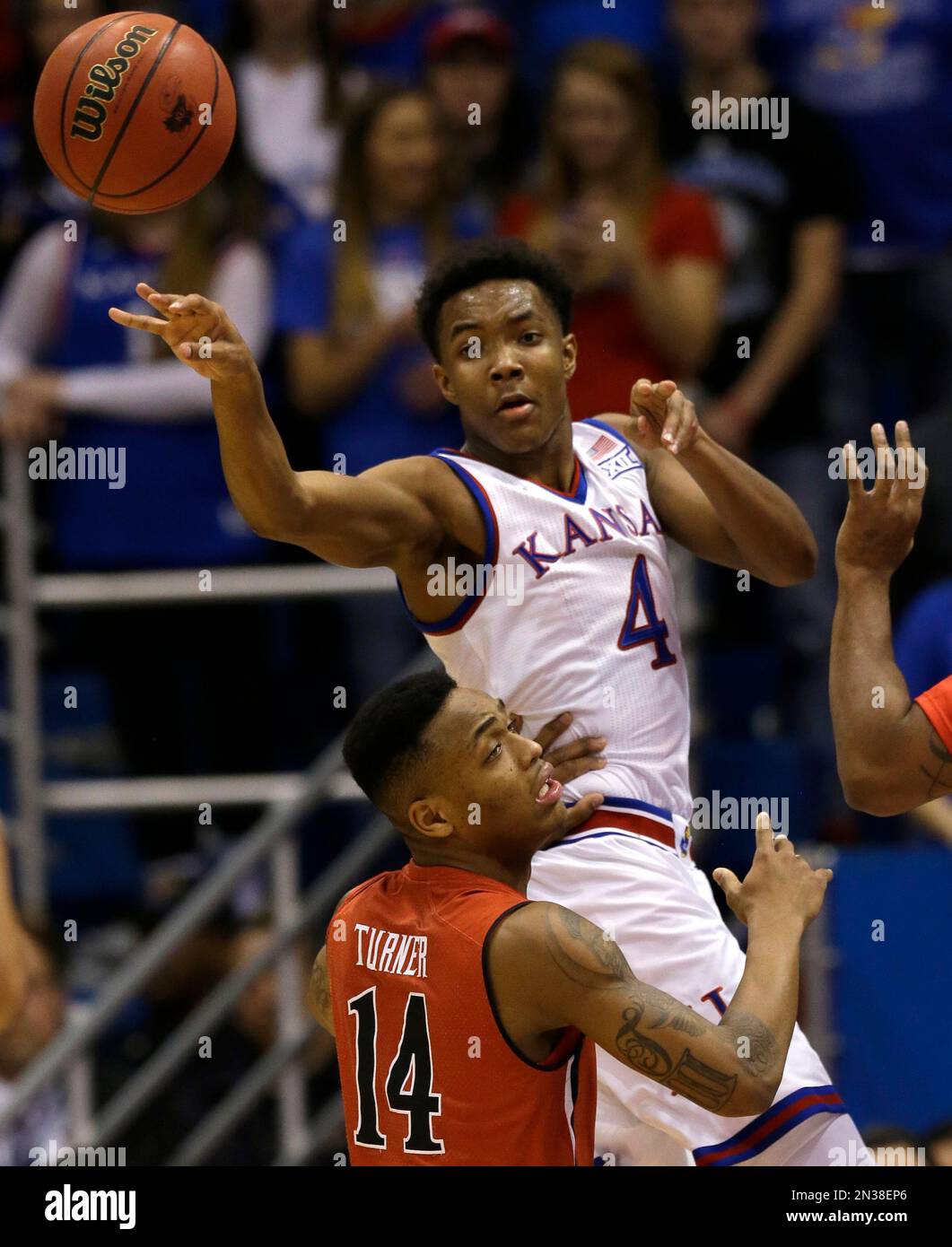Kansas guard Devonte Graham (4) passes to a teammate while covered by ...