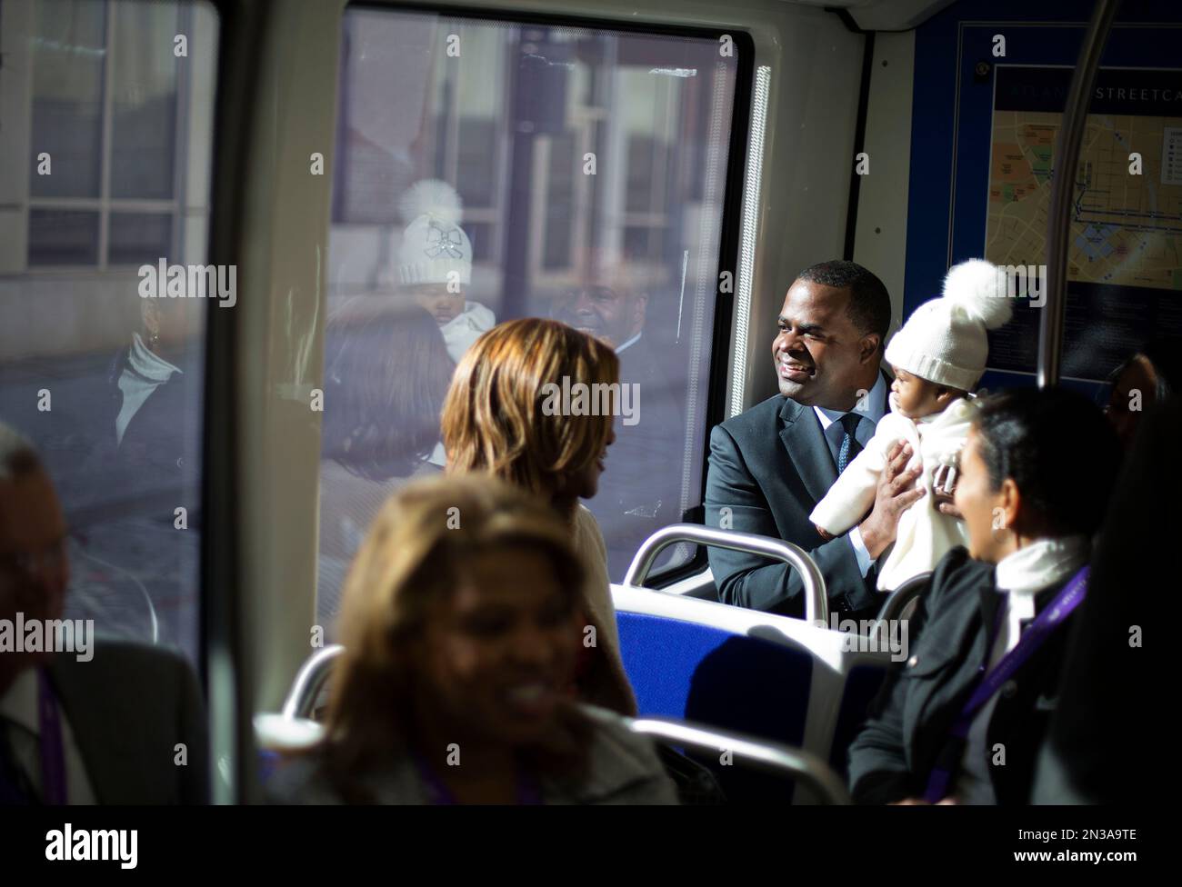 Atlanta Mayor Kasim Reed holds his six-month-old daughter Maria Kristan ...