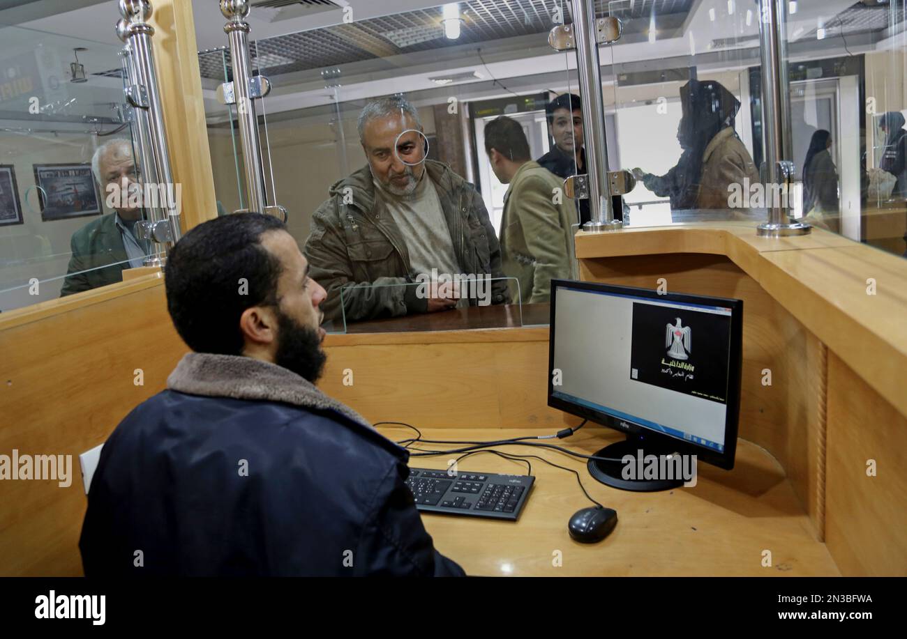 Palestinian passengers wait to stamp their passports as they come from ...