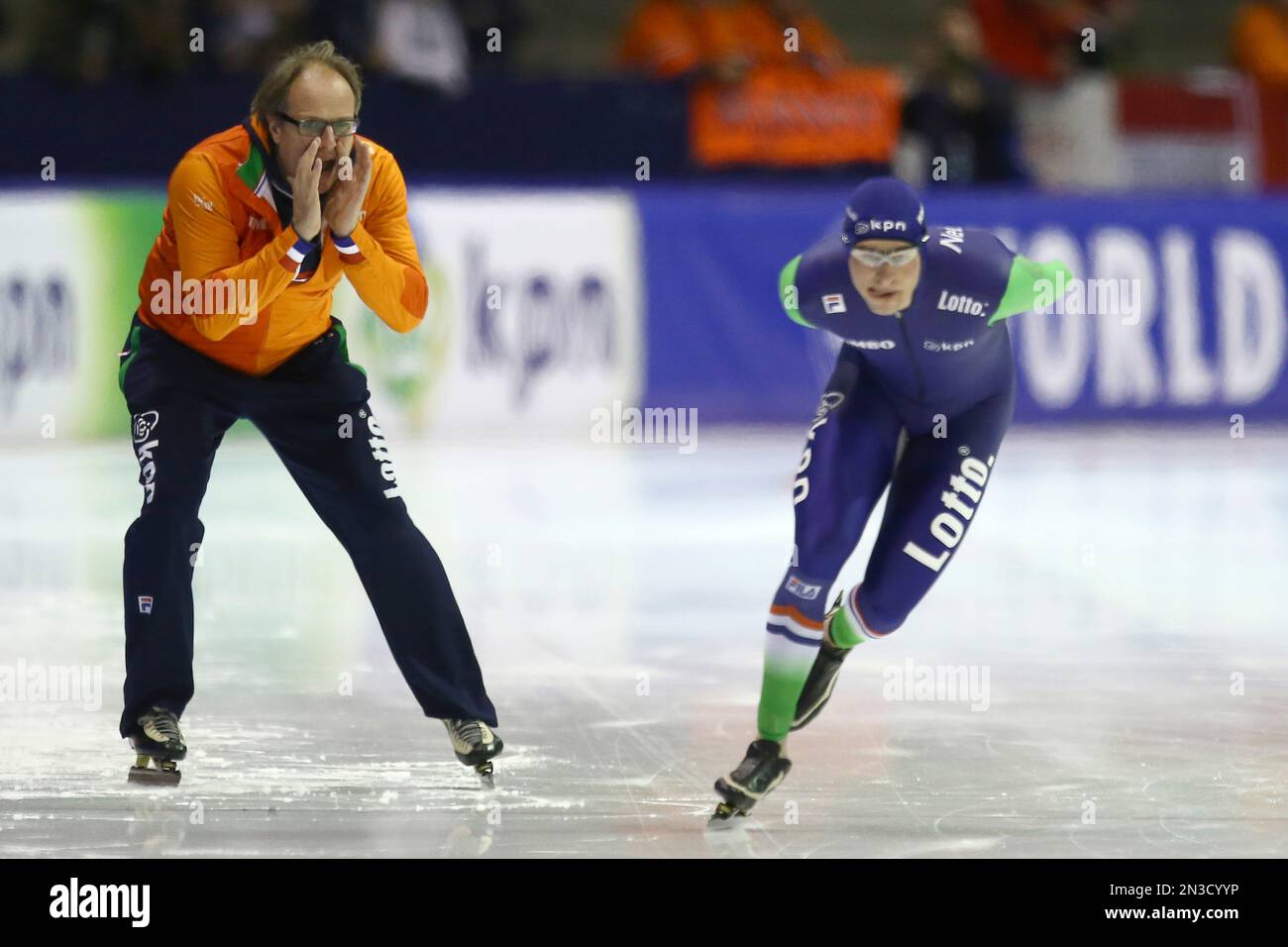 Coach Jac Orie of The Netherlands shouts encouragements to Sven Kramer of the Netherlands as he ...