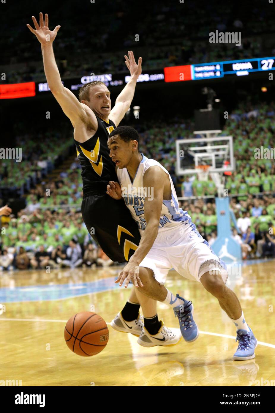 North Carolina's Marcus Paige dribbles around Iowa's Mike Gesell during ...