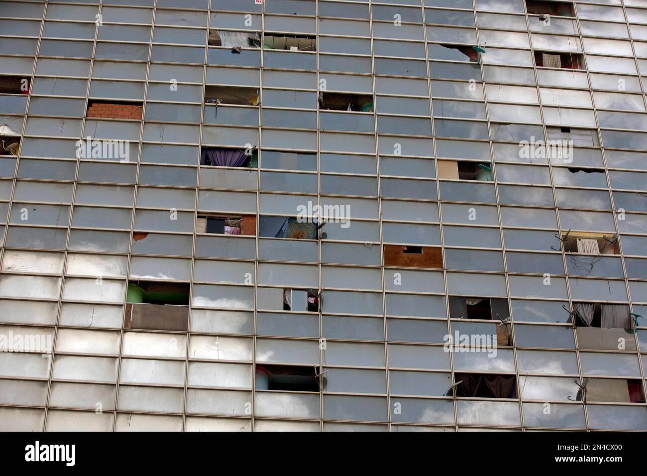 Broken windows are seen covered with wood planks at the the world’s ...