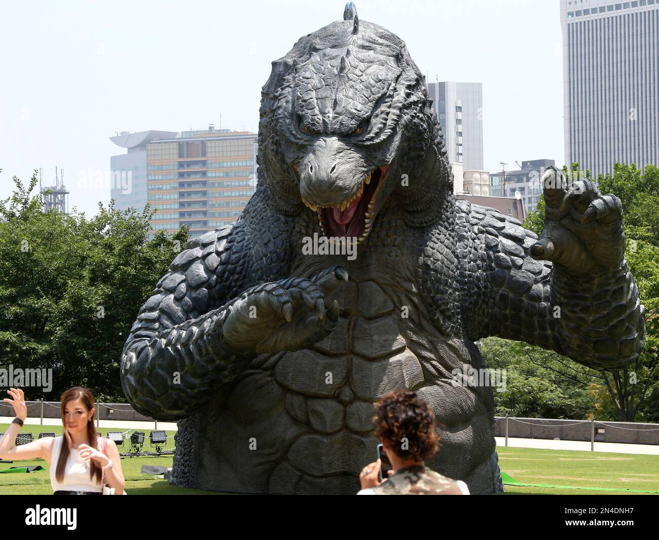 A couple takes a picture in front of a scaled down model of the new ...
