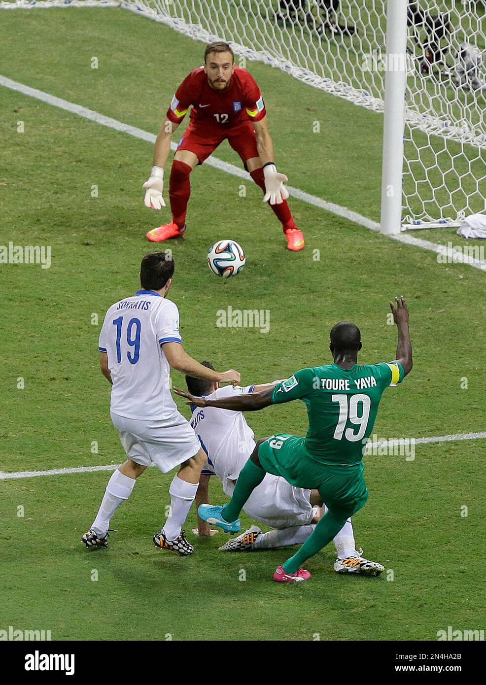 Greece's goalkeeper Panagiotis Glykos, top, makes a save on a shot by ...