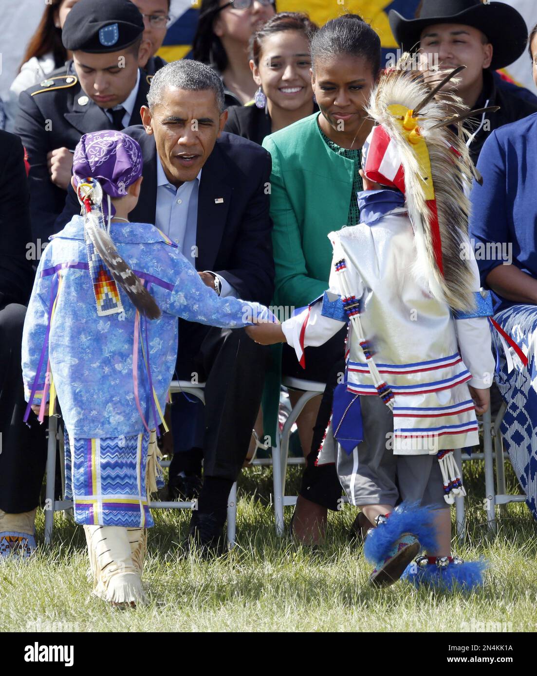 President Barack Obama calls over two young boys during a Native ...