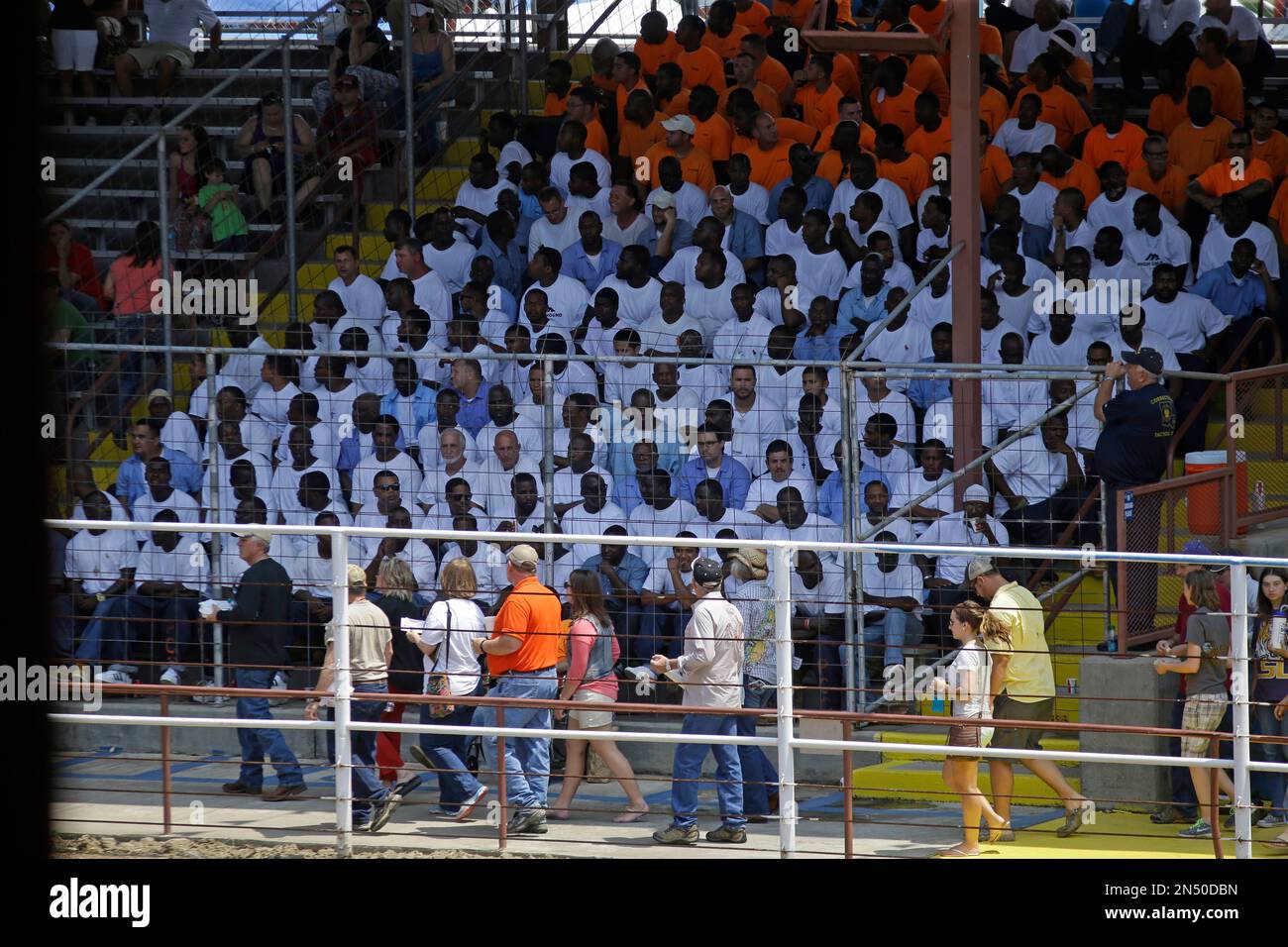 People walk past the inmate section in the stands at the Angola Prison ...
