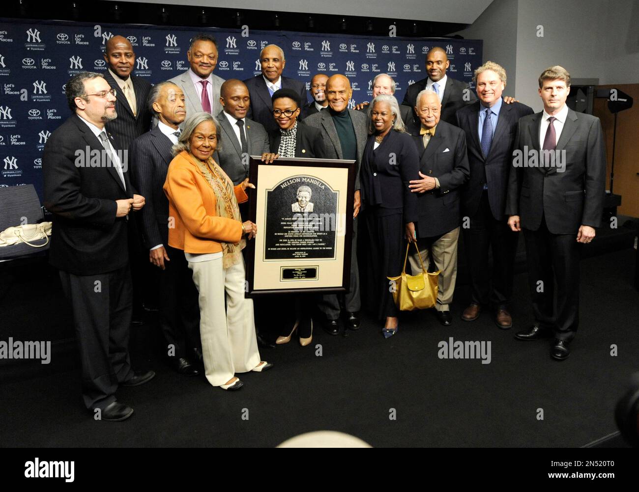 Dignitaries pose with a photo of a plaque honoring former South African ...