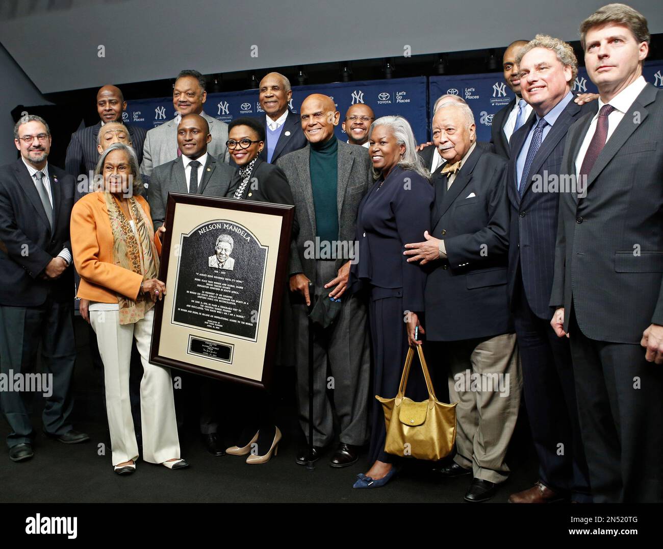 Dignitaries pose with a photo of a plaque honoring former South African ...