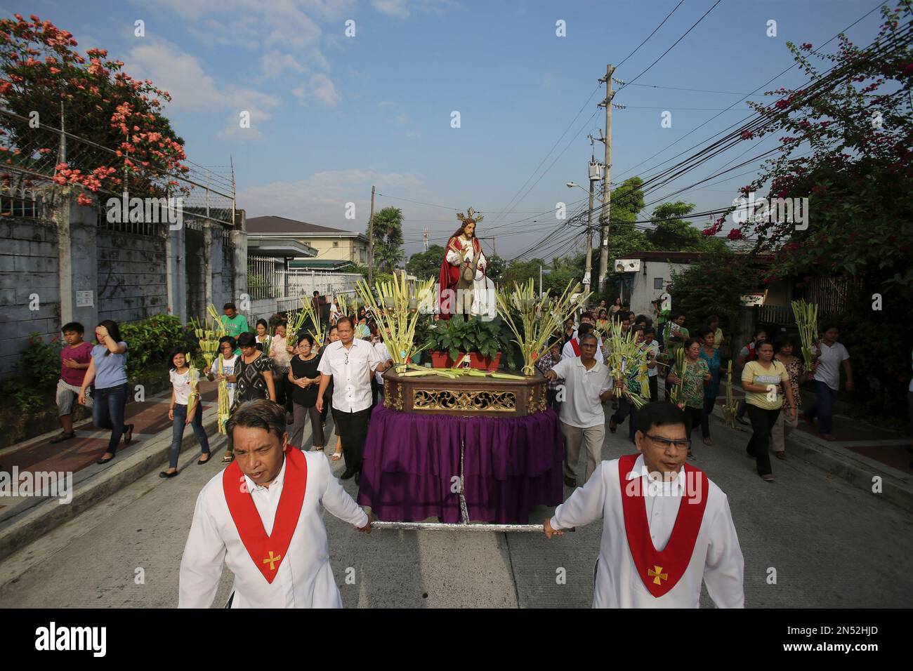Filipino devotees pull an image of Jesus Christ riding a donkey during ...