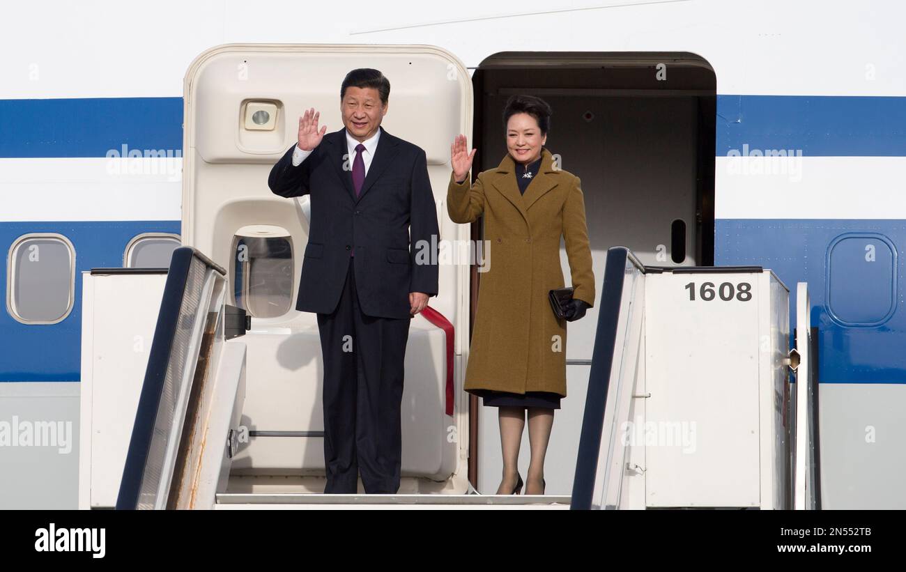 China's President Xi Jinping, left, and his wife Peng Liyuan wave as ...