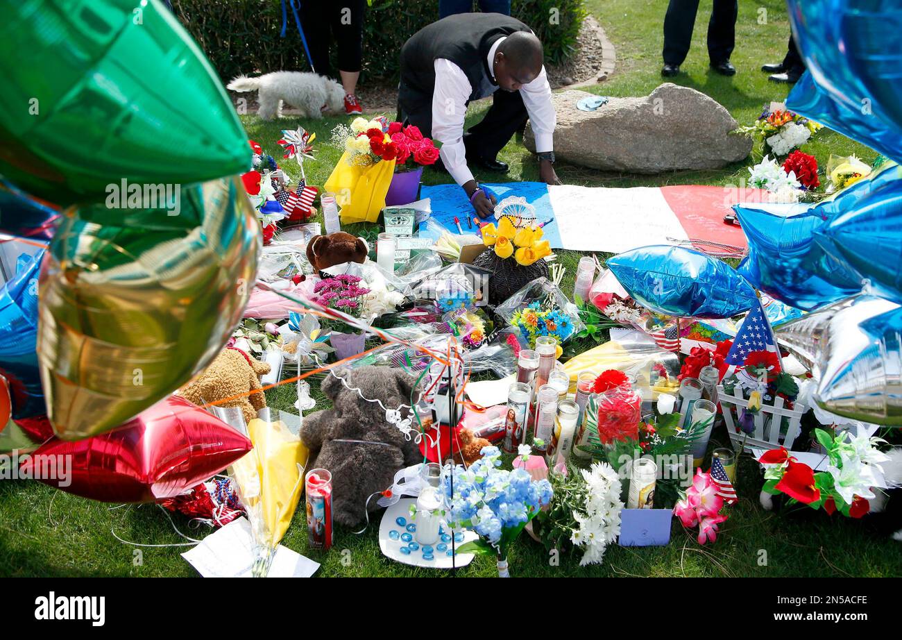 A visitor at a makeshift memorial for fallen Phoenix Police Detective ...