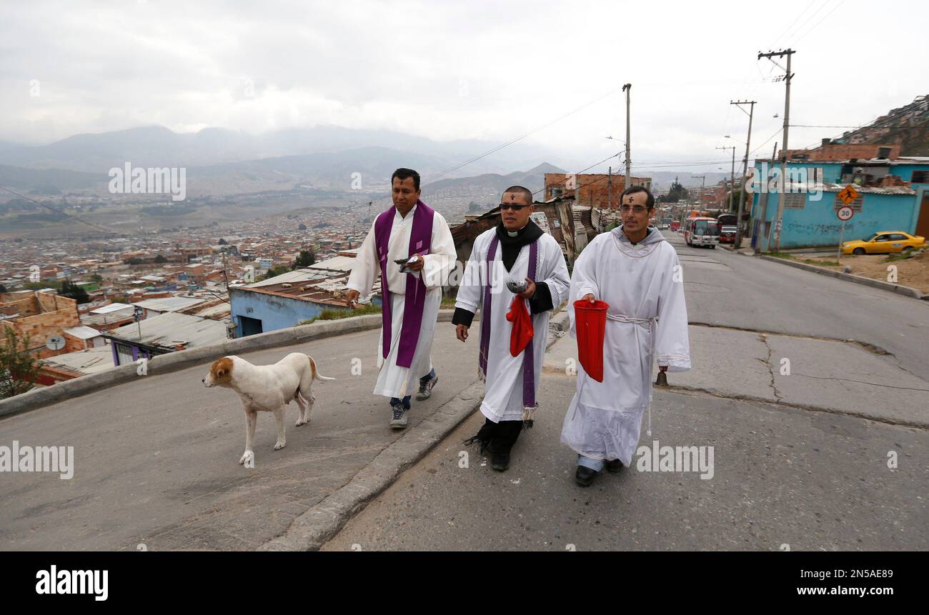 Catholic Priests Jesus Cardona, left, and Alvaro Morea, center, walk ...