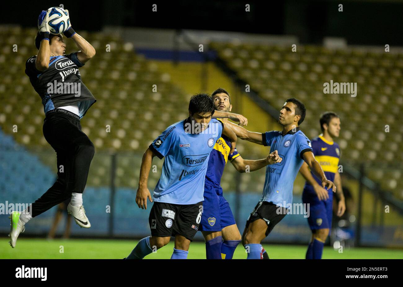 Belgrano's goalkeeper Pablo Heredia holds the ball as Boca Juniors ...