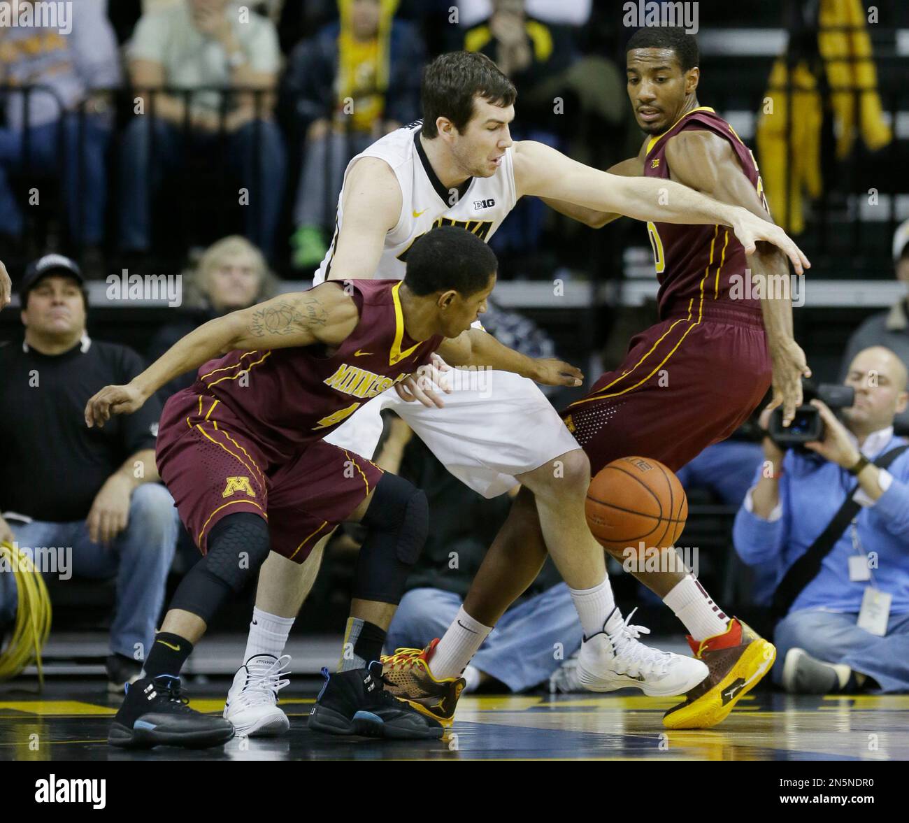 Iowa forward Zach McCabe, center, fights for a loose ball with ...