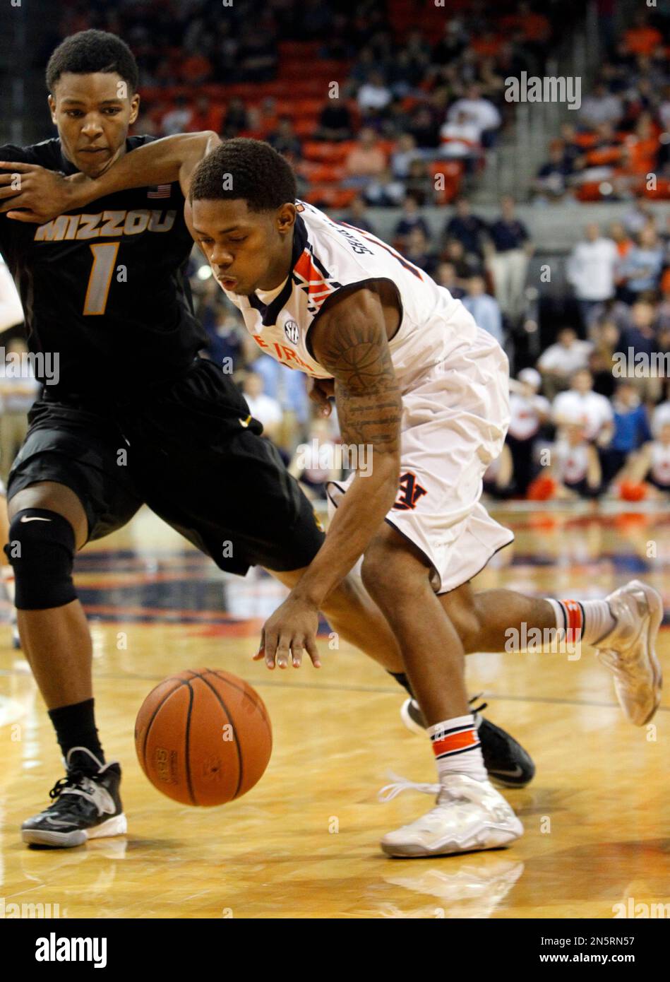 Auburn's Tahj Shamsid-Deen (13) drives to the basket around Missouri's ...