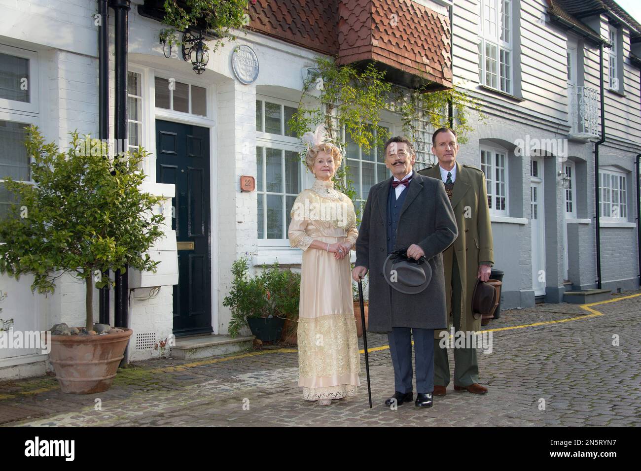 British actor Robert Powell, centre, dressed as the character Poirot ...