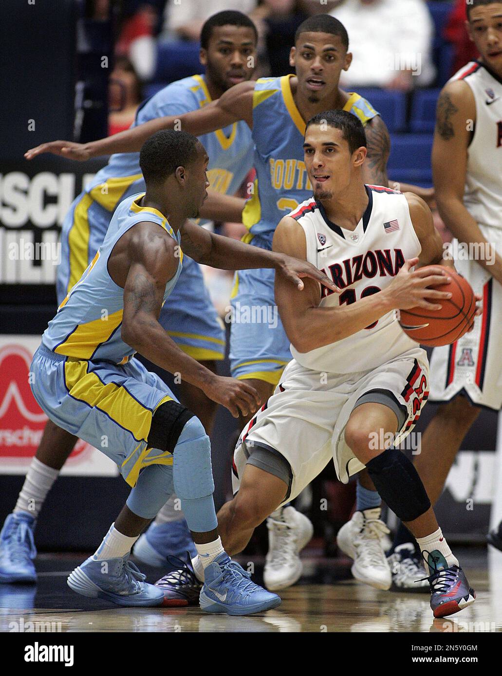 Arizona's Nick Johnson (13) is surrounded by Southern University's ...