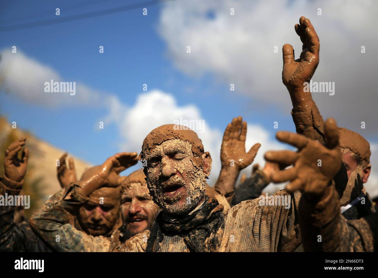 An Iranian Shiite is covered in mud during Ashoura rituals, marking the ...