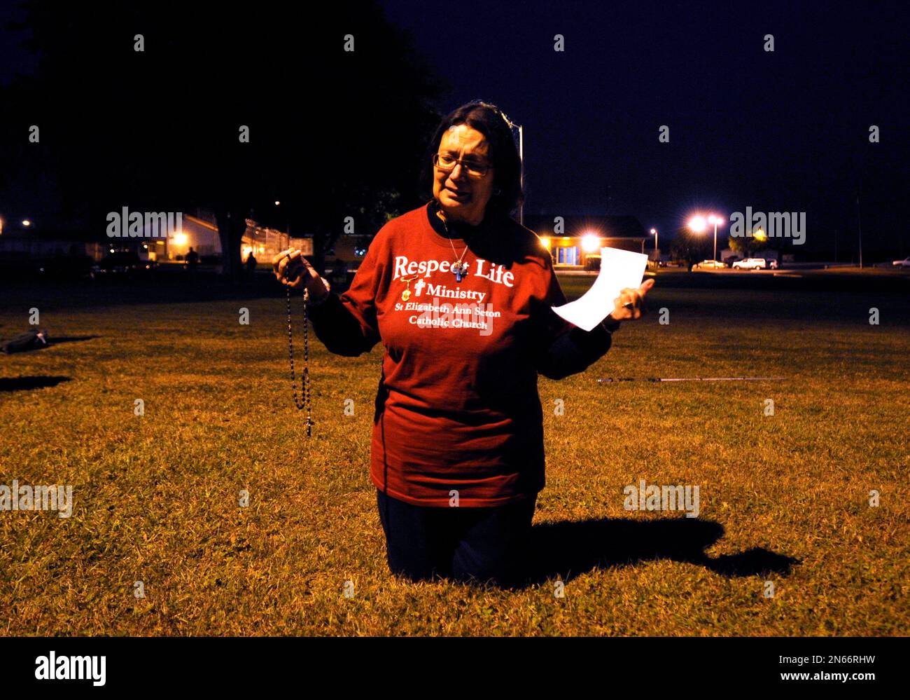 Hilda Rausini of Palm Coast, Fla., prays during a protest against the ...