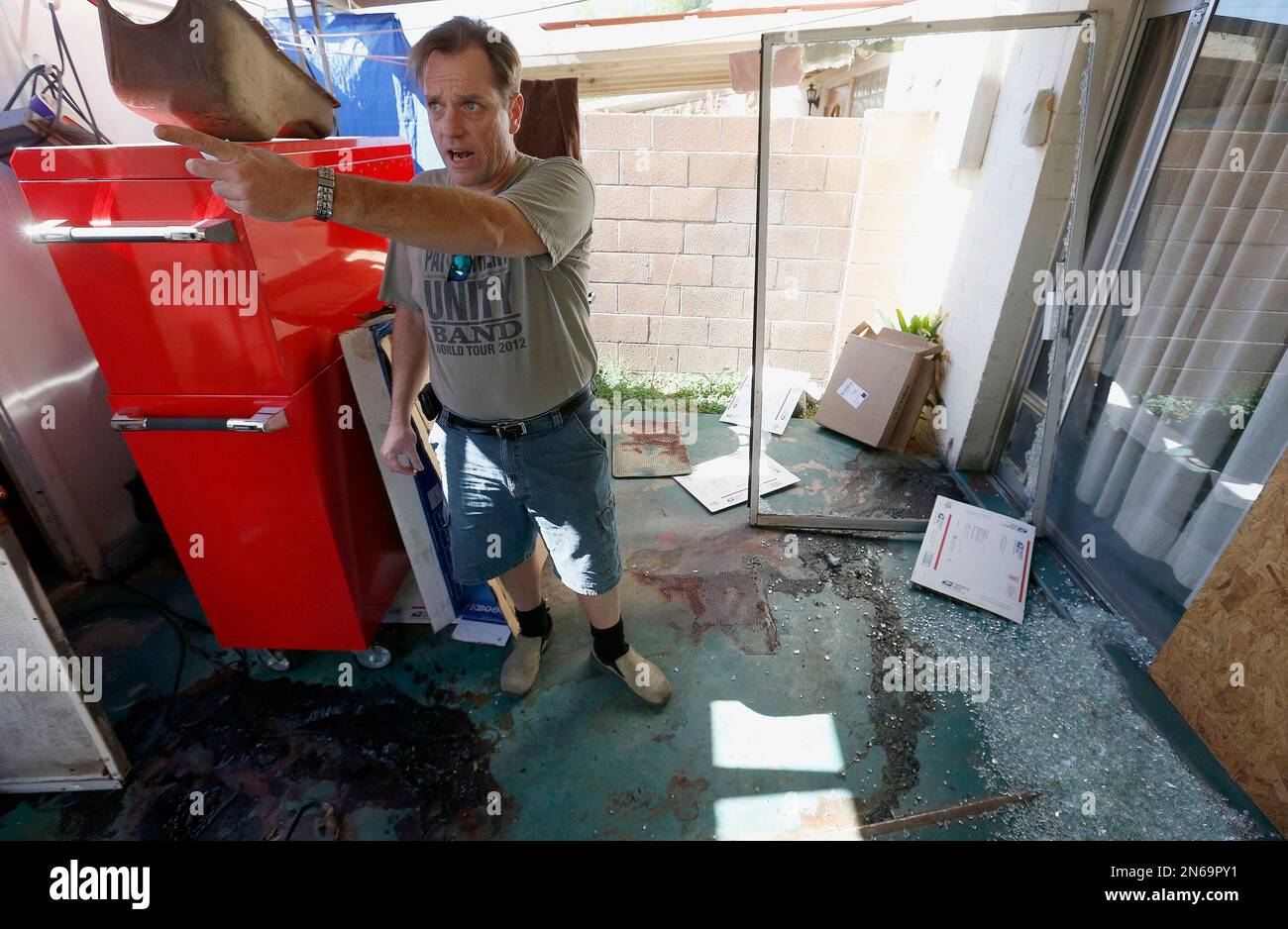 Patrick Riley, brother of shooting victim Michael Moore, points to ...