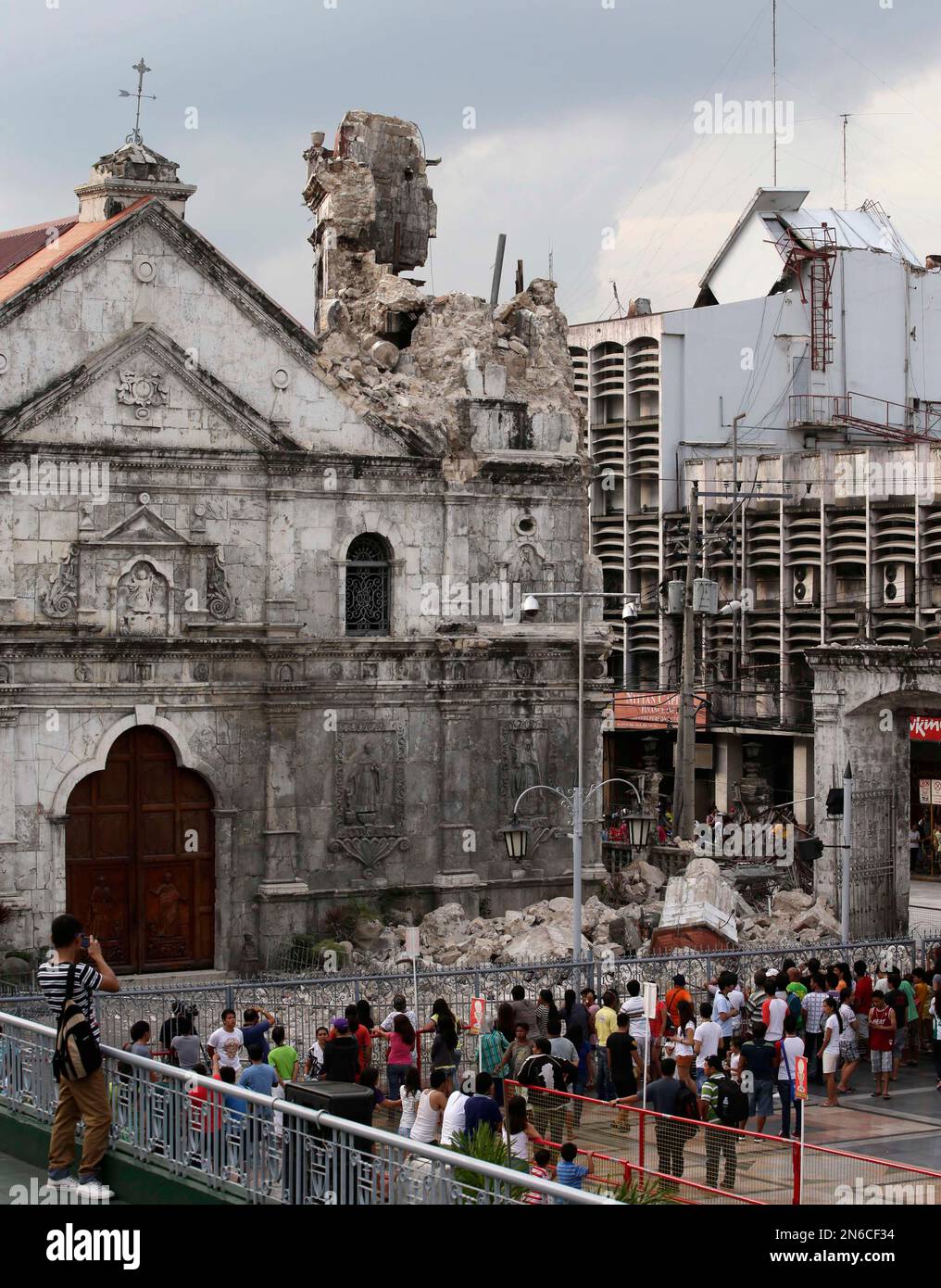 Residents look at the Basilica De Sto. Nino, or Basilica of the Holy ...