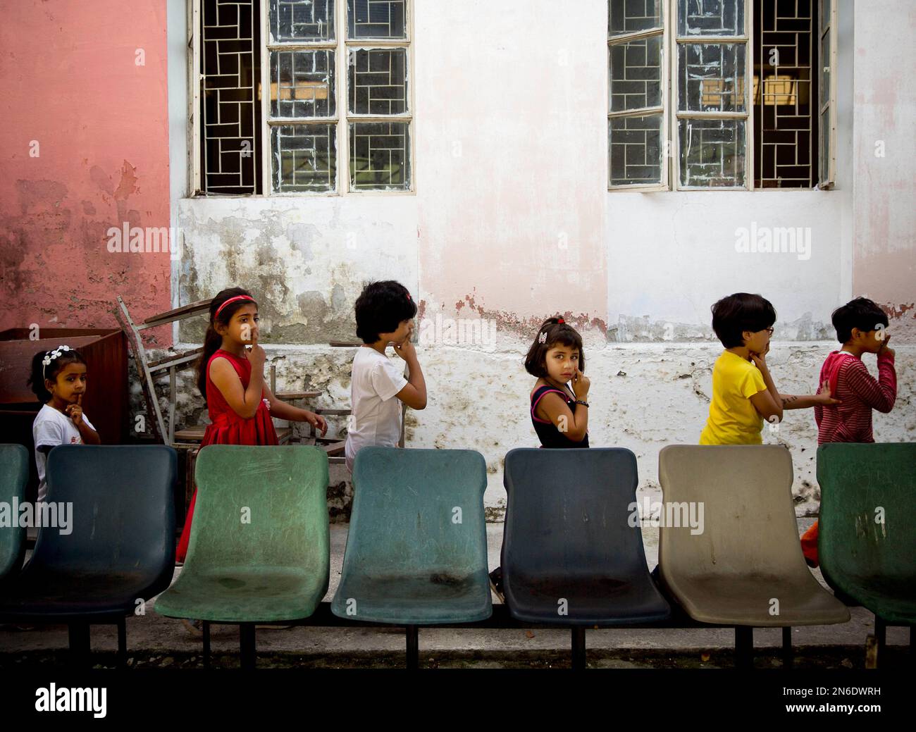 Pakistani elementary students walk to their classroom after their ...