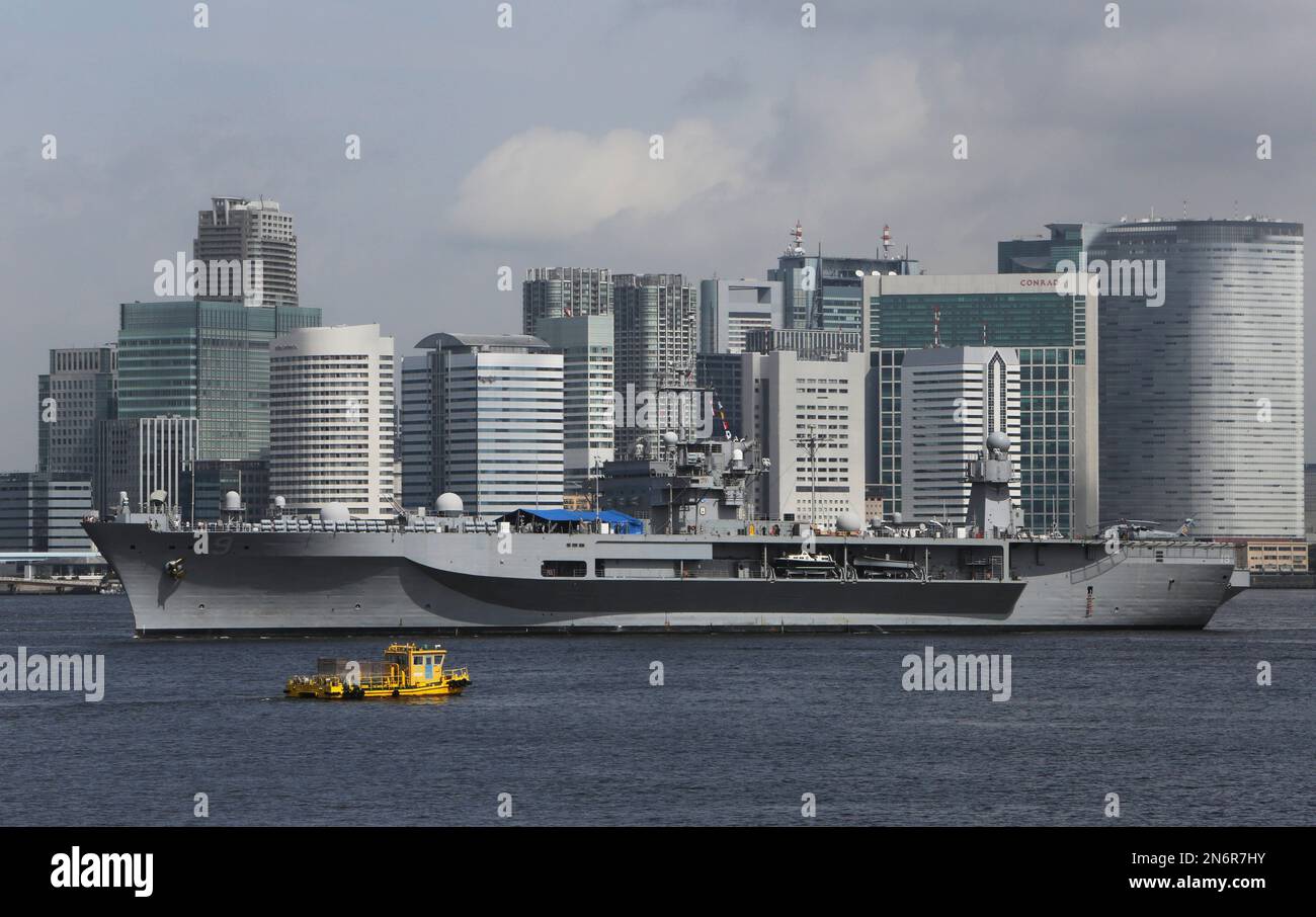The USS Blue Ridge passes buildings on the Tokyo skyline as it sails ...