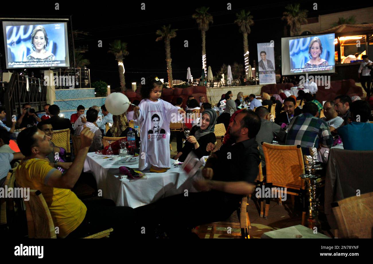 Palestinians watch the televised performance of Mohamm3d Assaf, 23, a ...