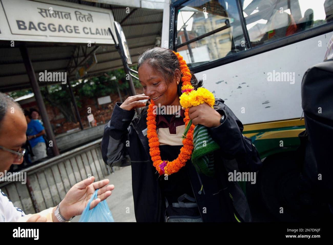 Arunima Sinha, center, is garlanded as she arrives at the airport in ...