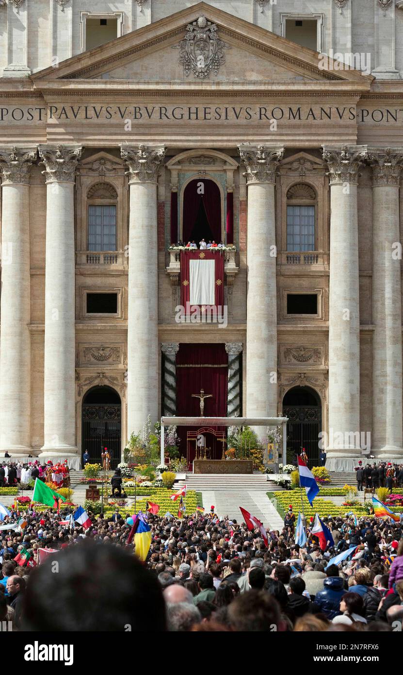 Pope Francis waves from the loggia of St. Peter's Basilica to the crowd ...