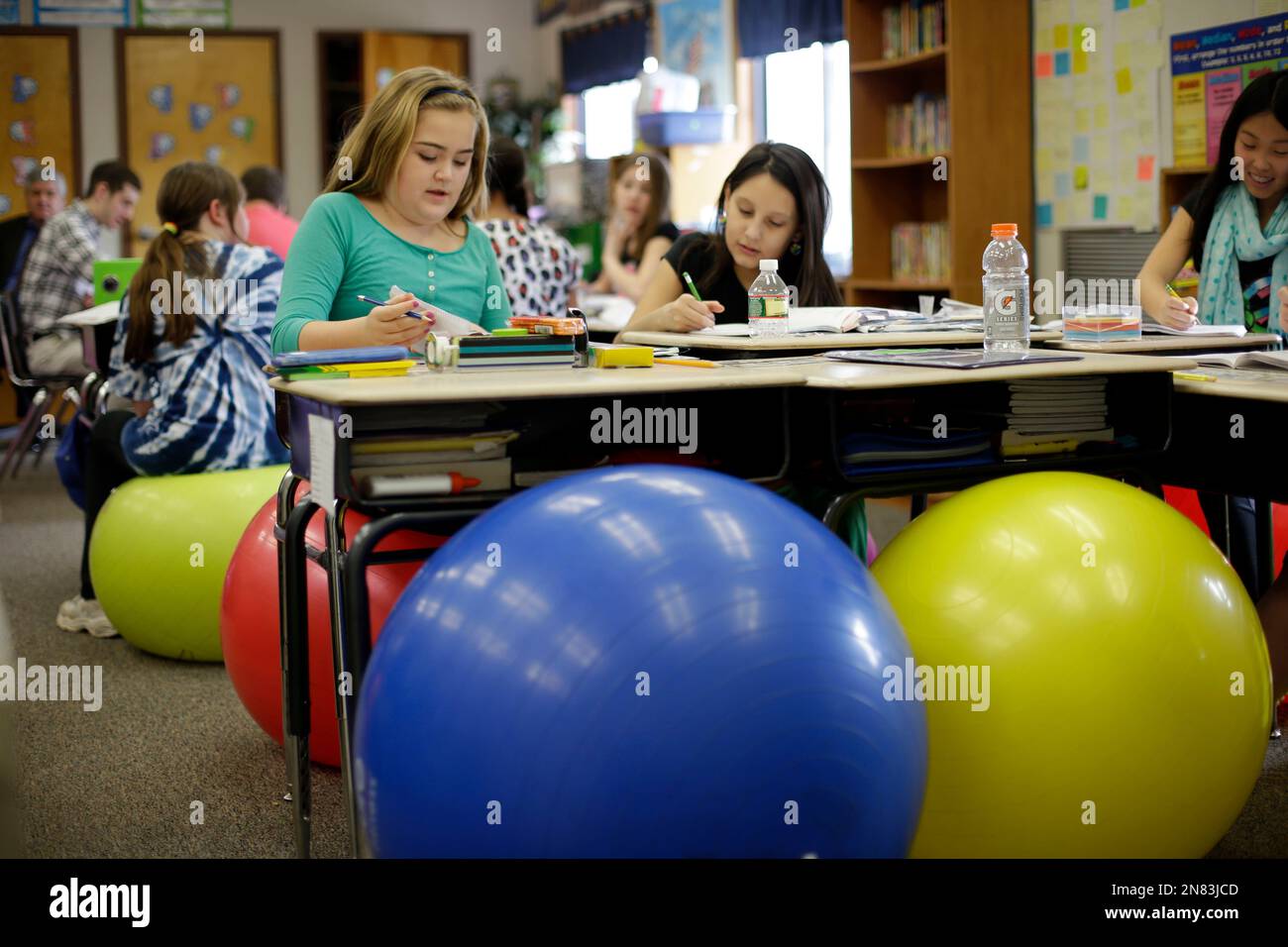 Students in Robbi Giuliano's fifth grade class sit on yoga balls as ...