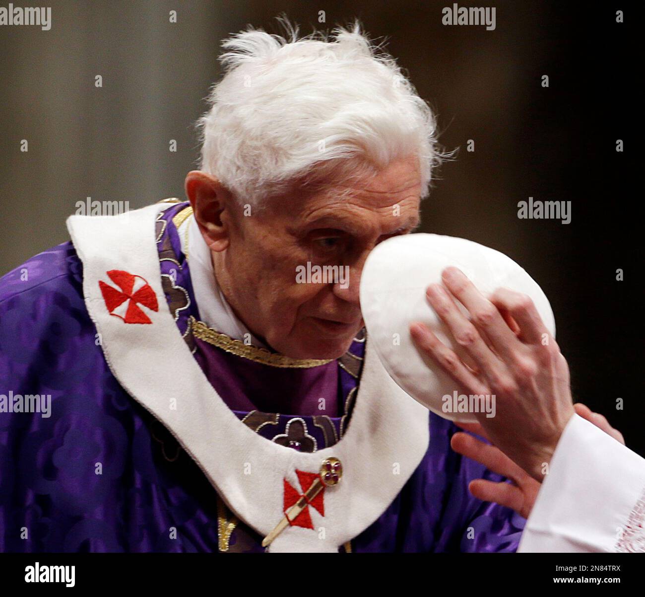 Bishop Guido Marini holds Pope Benedict XVI's skull cap during the Ash ...