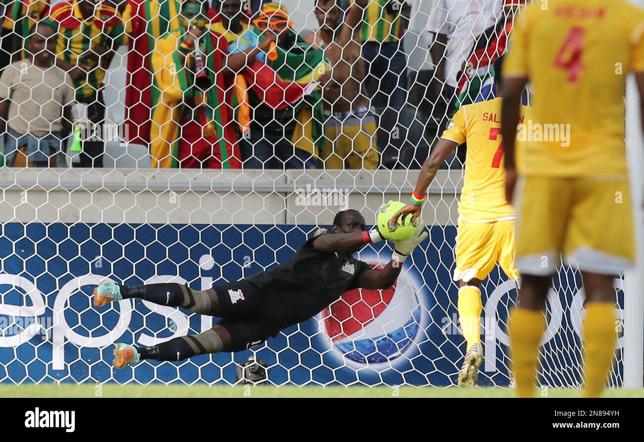 Zambia's goalkeeper Kennedy Mweene, left, dives to save a penalty kick ...