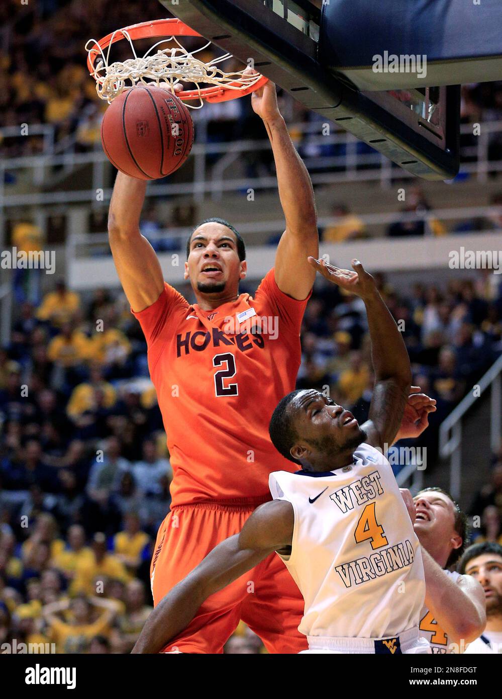 Virginia Tech's Joey van Zegeren (2) dunks over West Virginia's Jabarie ...