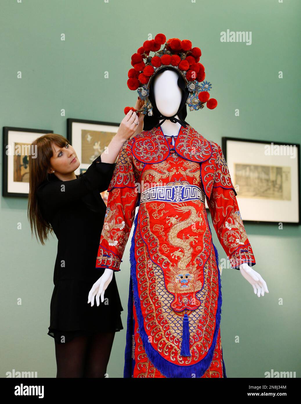 Christie's specialist Caitlin Graham adjusts a Chinese dancing costume ...