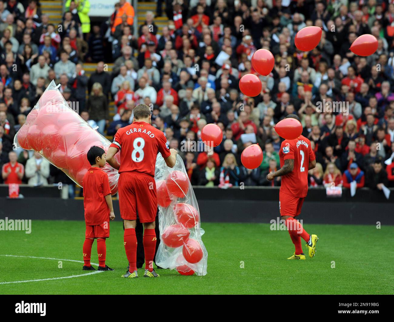 Liverpool captain Steven Gerrard, center, takes part in releasing 96 ...