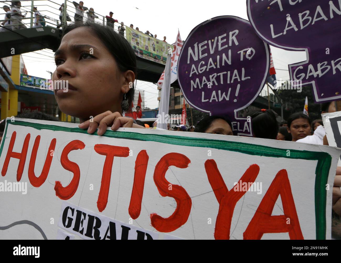 Protesters display placards as they gather at Mendiola Bridge leading ...
