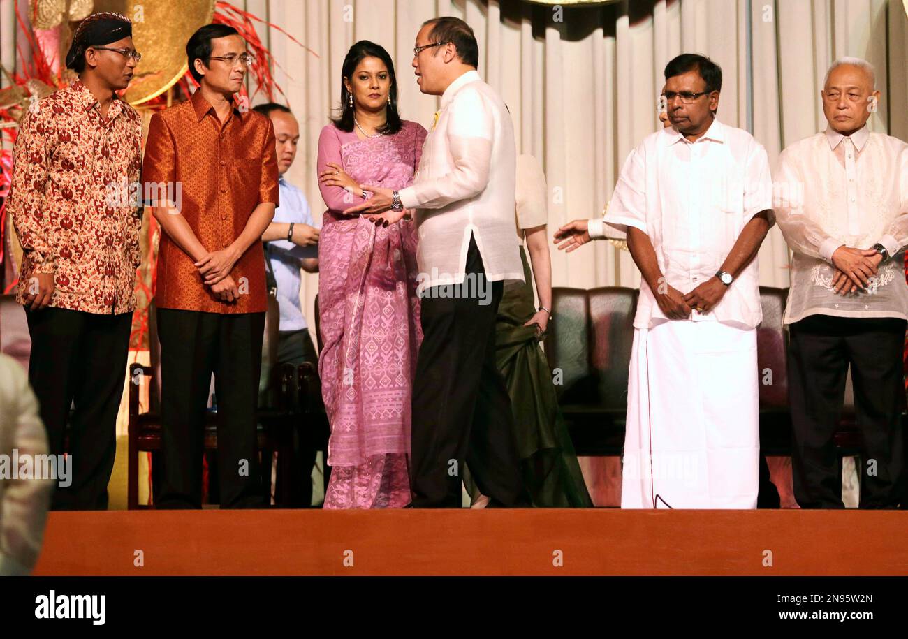 Philippine President Benigno Aquino III, fourth from left, talks to ...