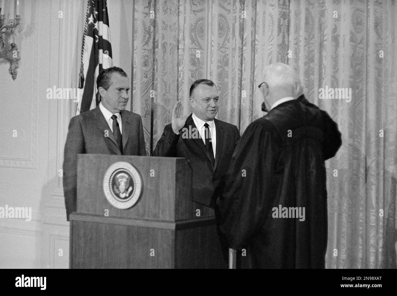 Walter J. Hickel, center, Secretary of the Interior shown taking the ...